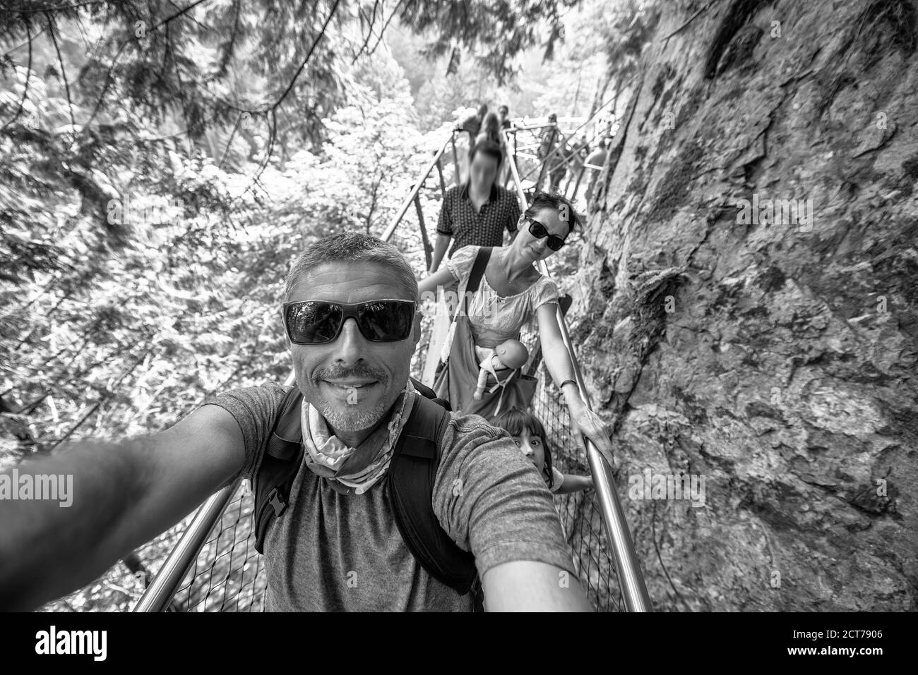 Family excursion over a bridge in the forest Stock Photo - Alamy