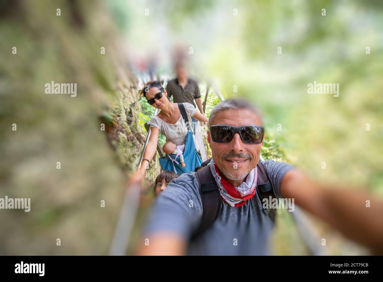 Family excursion over a bridge in the forest Stock Photo - Alamy