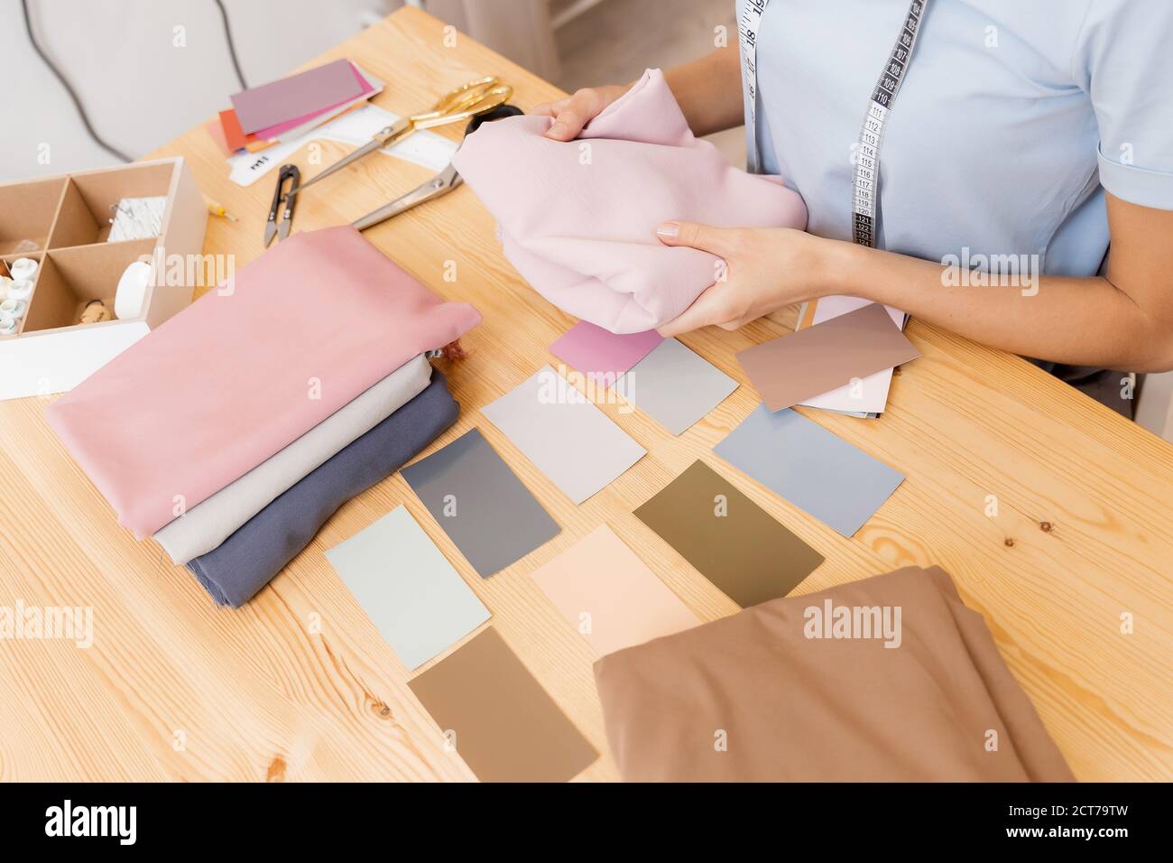 Female designer dressmaker Working on sewing machine in studio. Forms ...