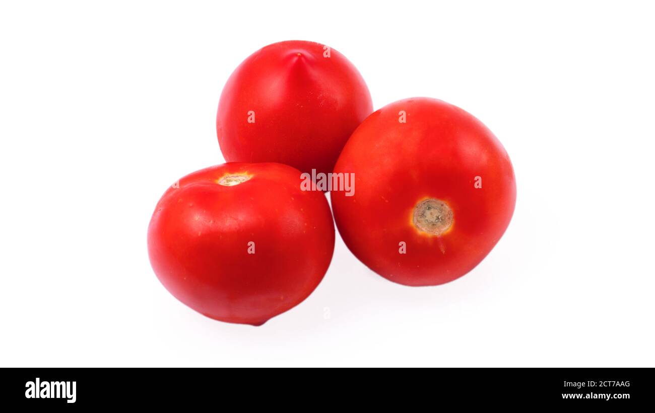 Three whole red tomatoes on a white background in isolation Stock Photo - Alamy