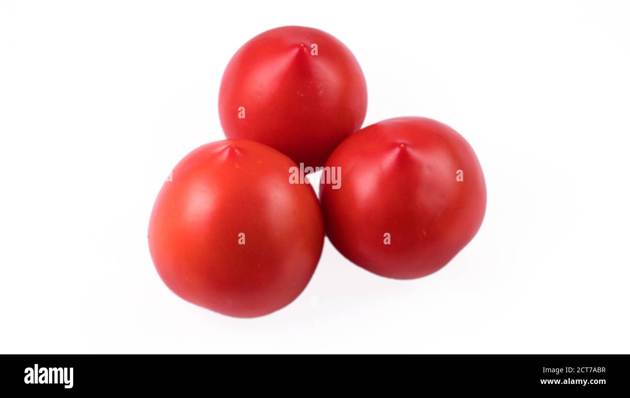 Three whole red tomatoes on a white background in isolation Stock Photo - Alamy