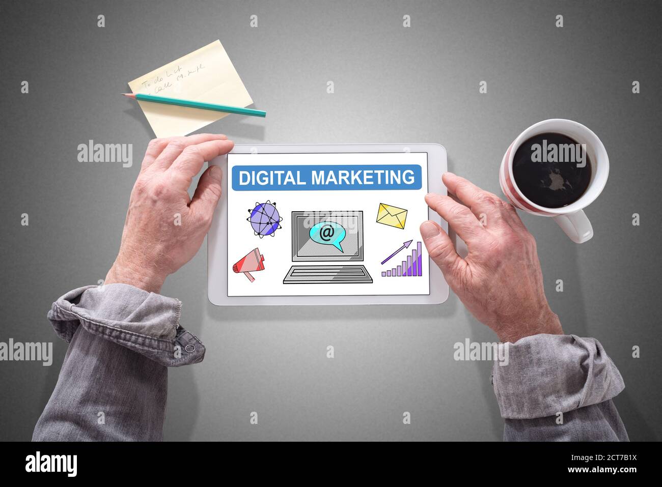 Male hands using a tablet showing digital marketing concept Stock Photo ...