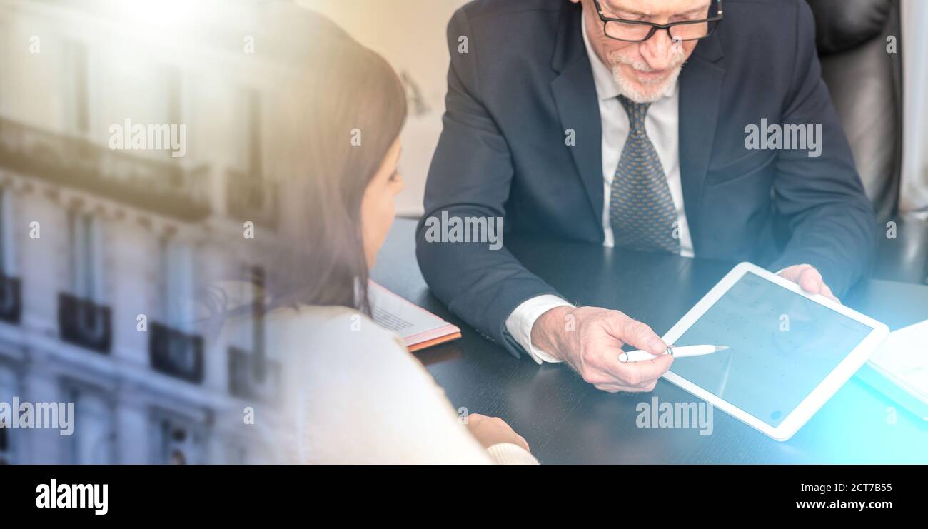 Consultant advising young woman at office; multiple exposure Stock ...