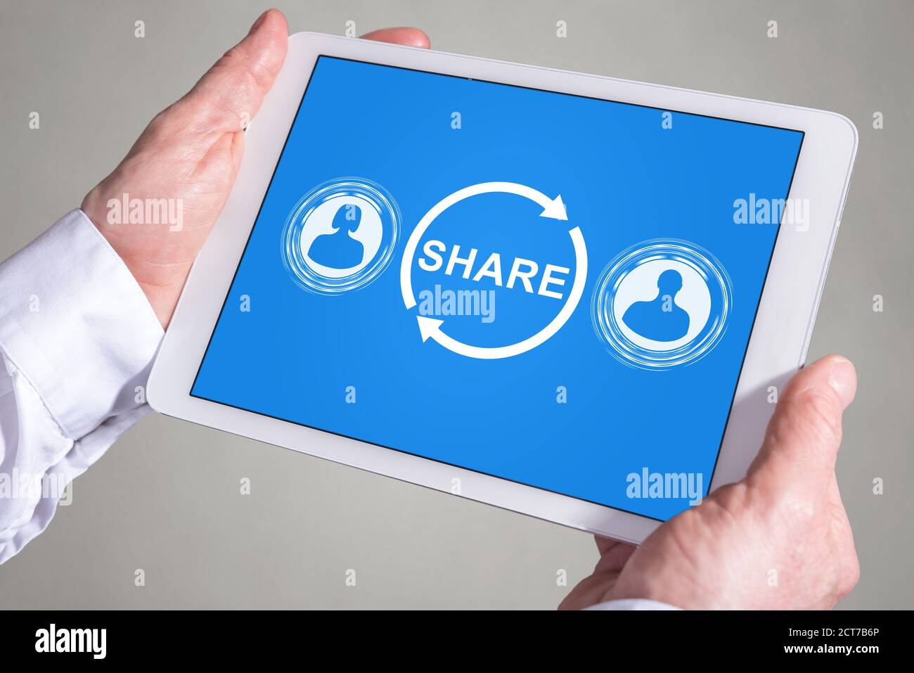 Tablet screen displaying a share concept Stock Photo - Alamy