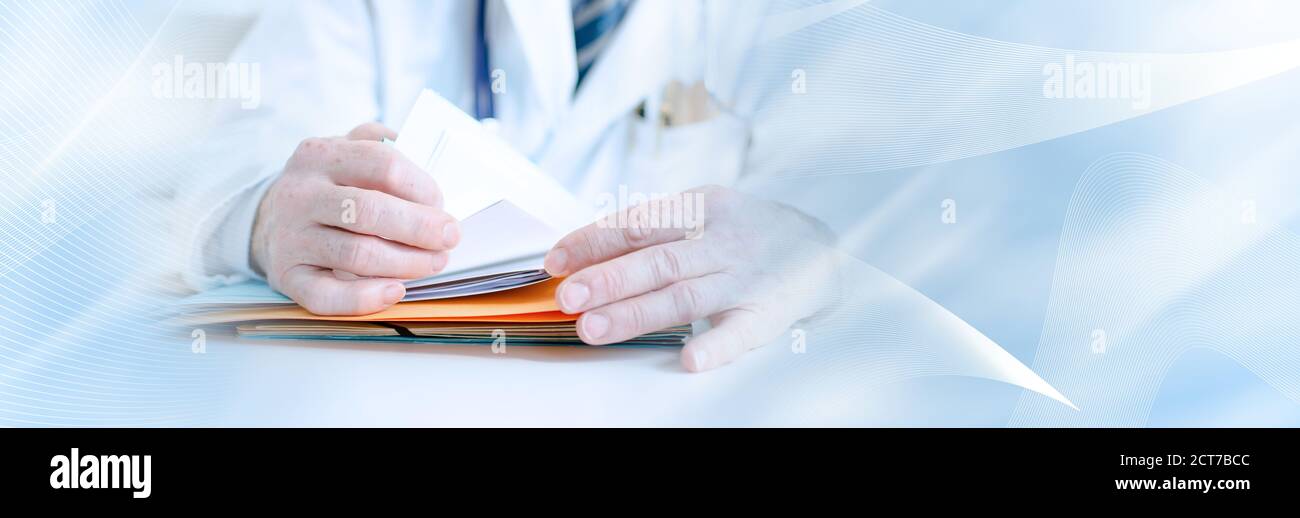 Doctor looking for a file in his office; panoramic banner Stock Photo ...