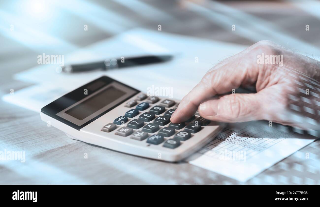 Male hand using calculator, accounting concept; multiple exposure Stock ...