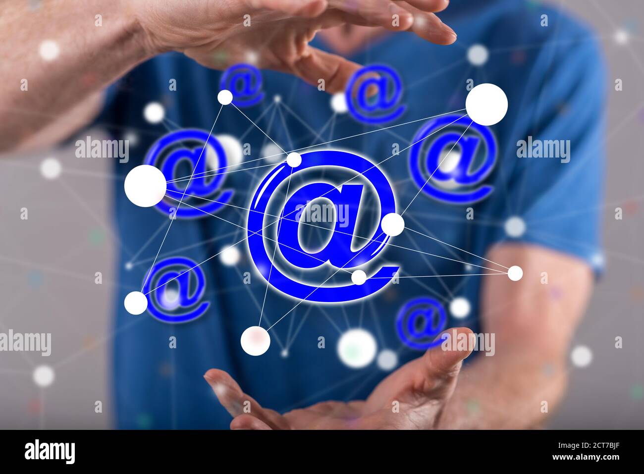 Email concept between hands of a man in background Stock Photo - Alamy