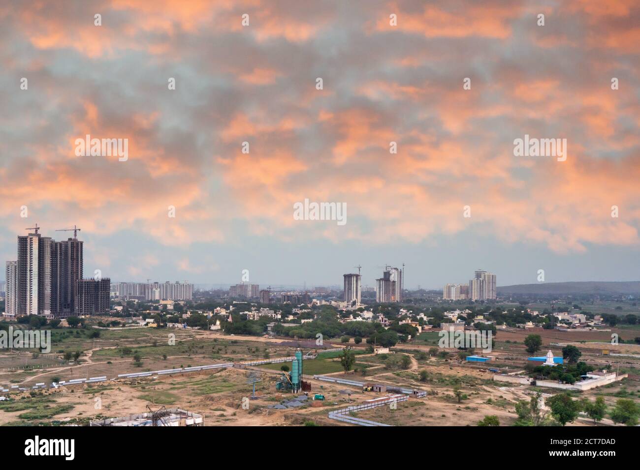 Aerial dusk shot of buuldings with warm orange lights shining out of ...