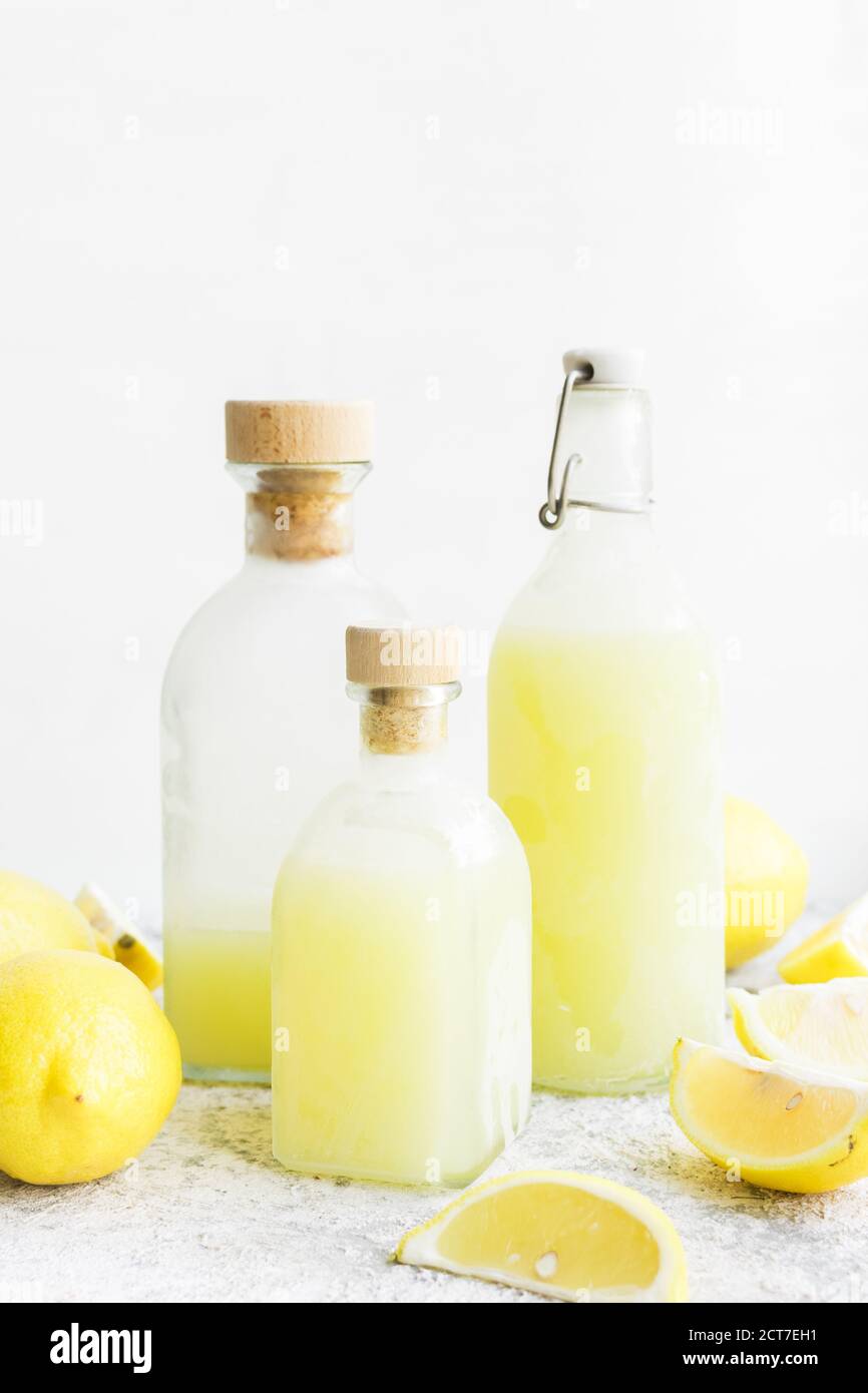 Bottles with traditional homemade lemon liqueur limoncello and fresh ...