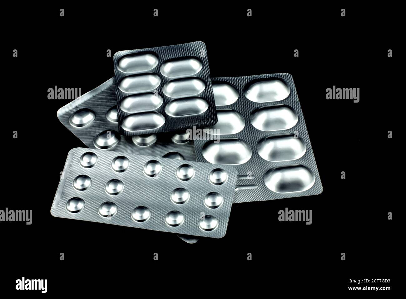 Foil medicine blister pack tablet containers isolated on a black ...