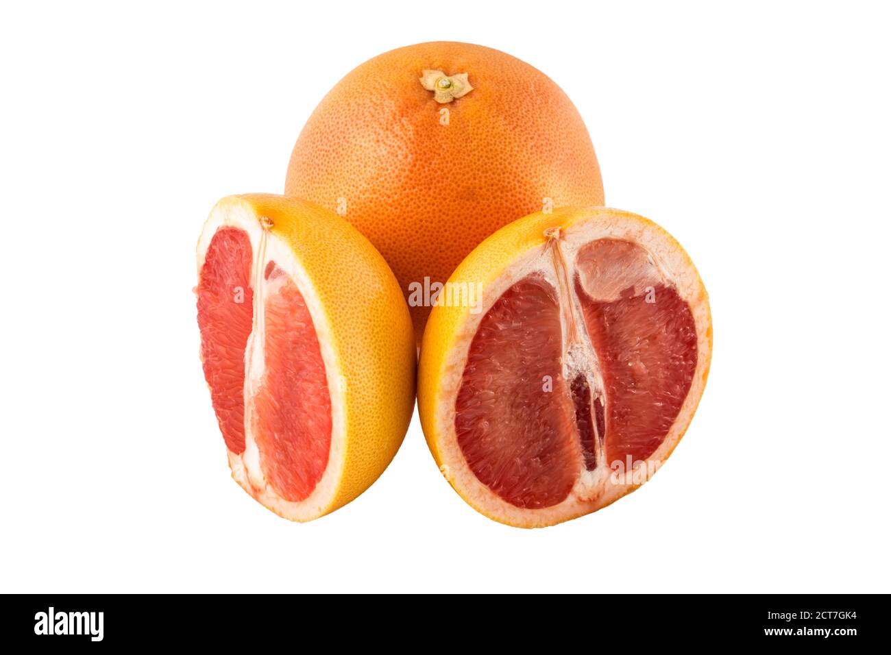 One whole grapefruit and also sliced pieces of grapefruit on a white ...