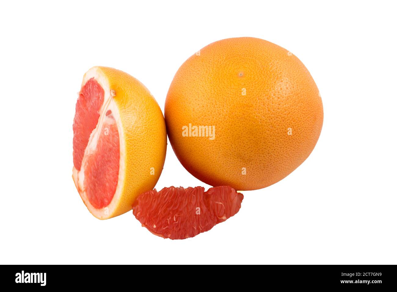 One whole grapefruit and also sliced pieces of grapefruit on a white ...