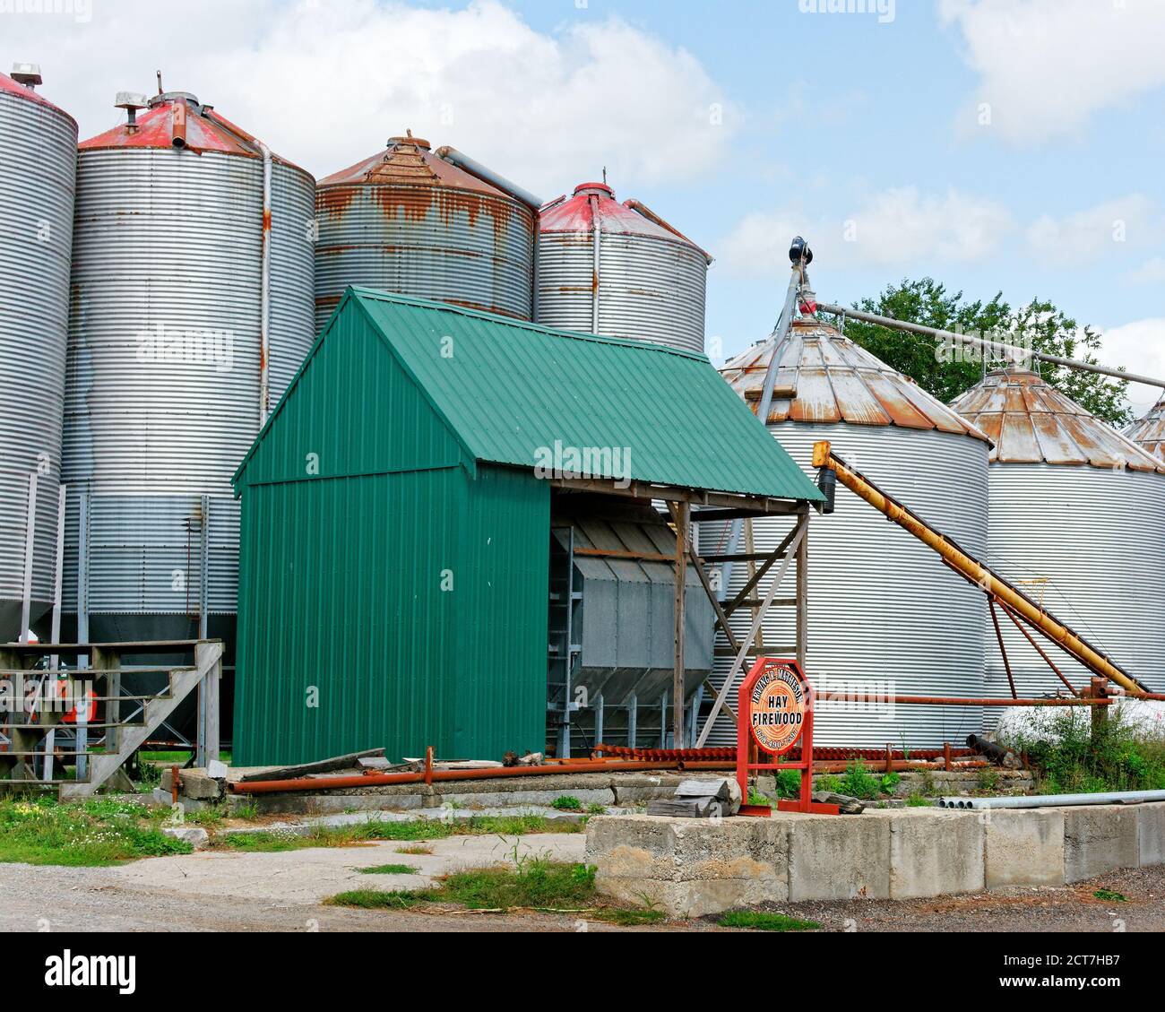 Sign reading Hay and Firewood is displayed in front of two rows of ...