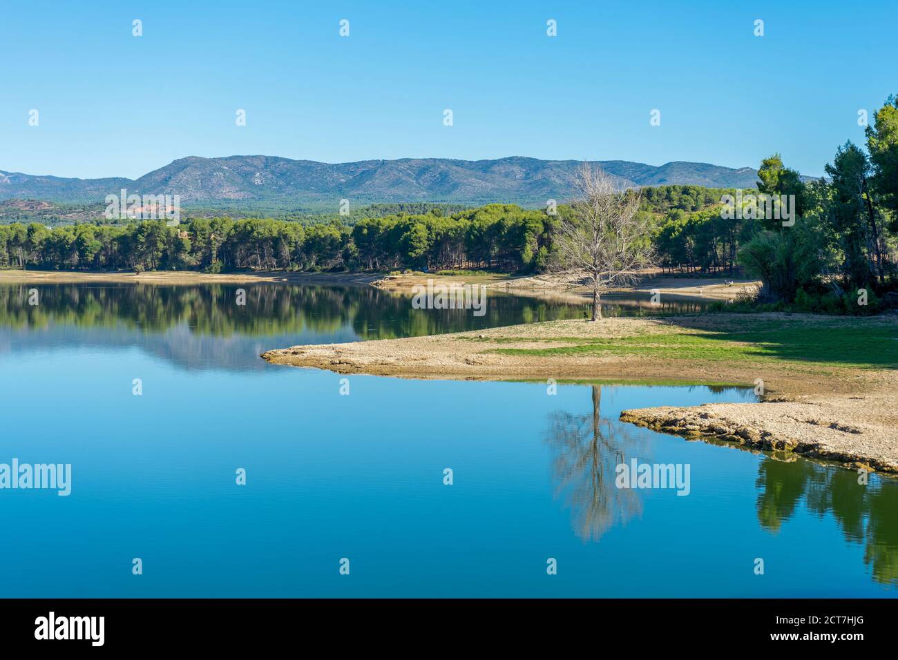 Reservoir landscape with nice reflections of the forest in the water on ...