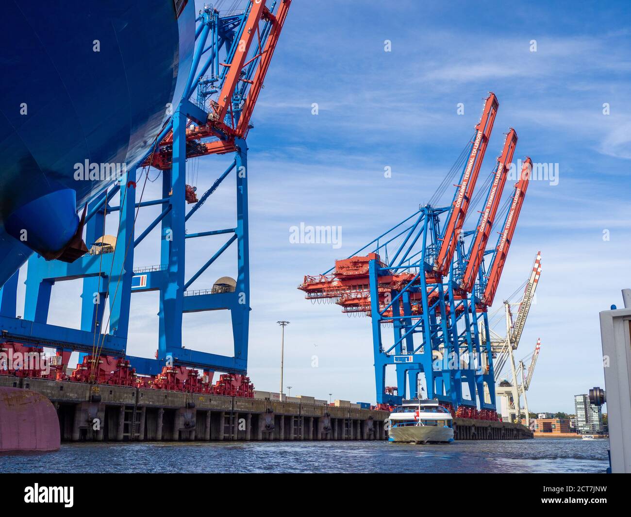 next to a container ship there are large container cranes for loading ...