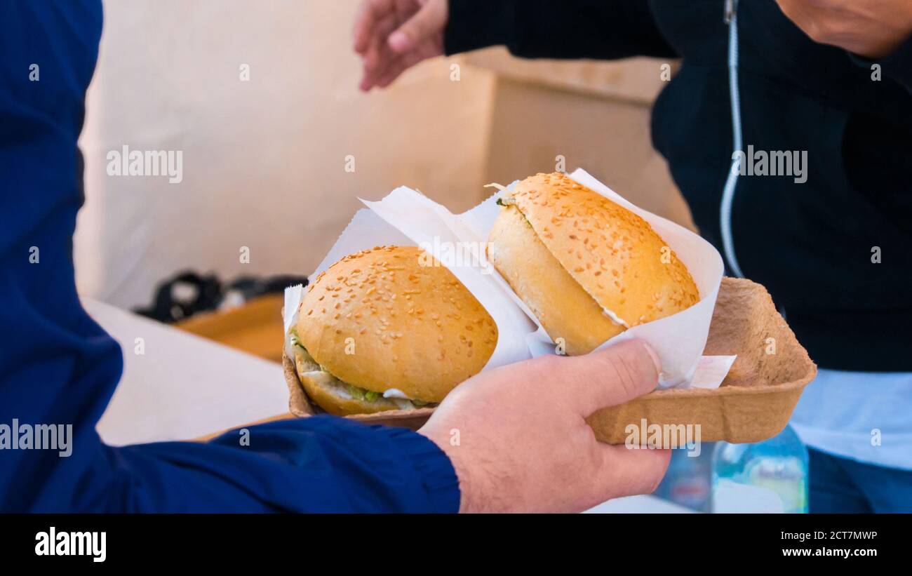 Man hands taking burger close hi-res stock photography and images - Alamy