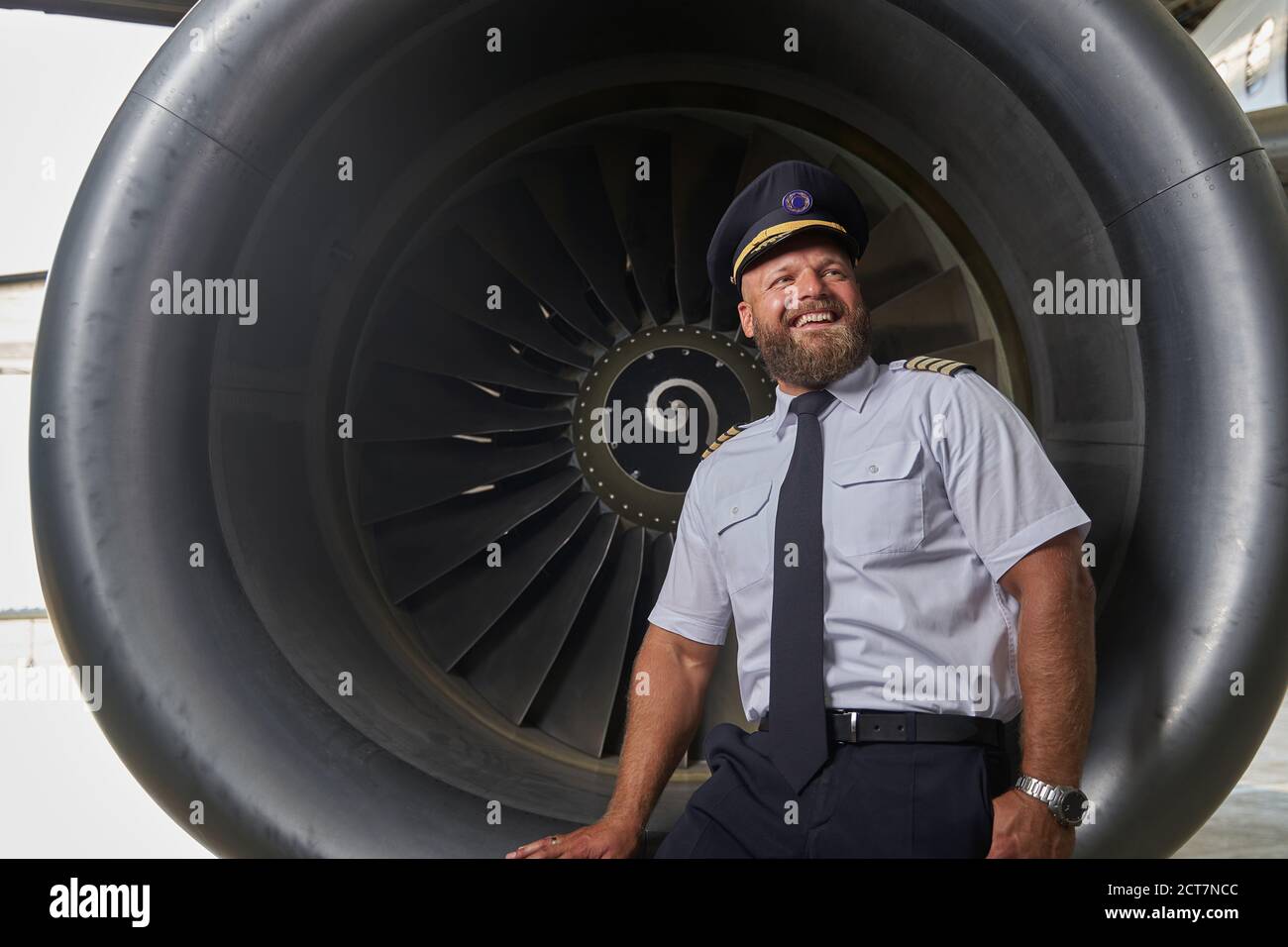 Happy optimistic pilot posing on the plane turbine Stock Photo - Alamy