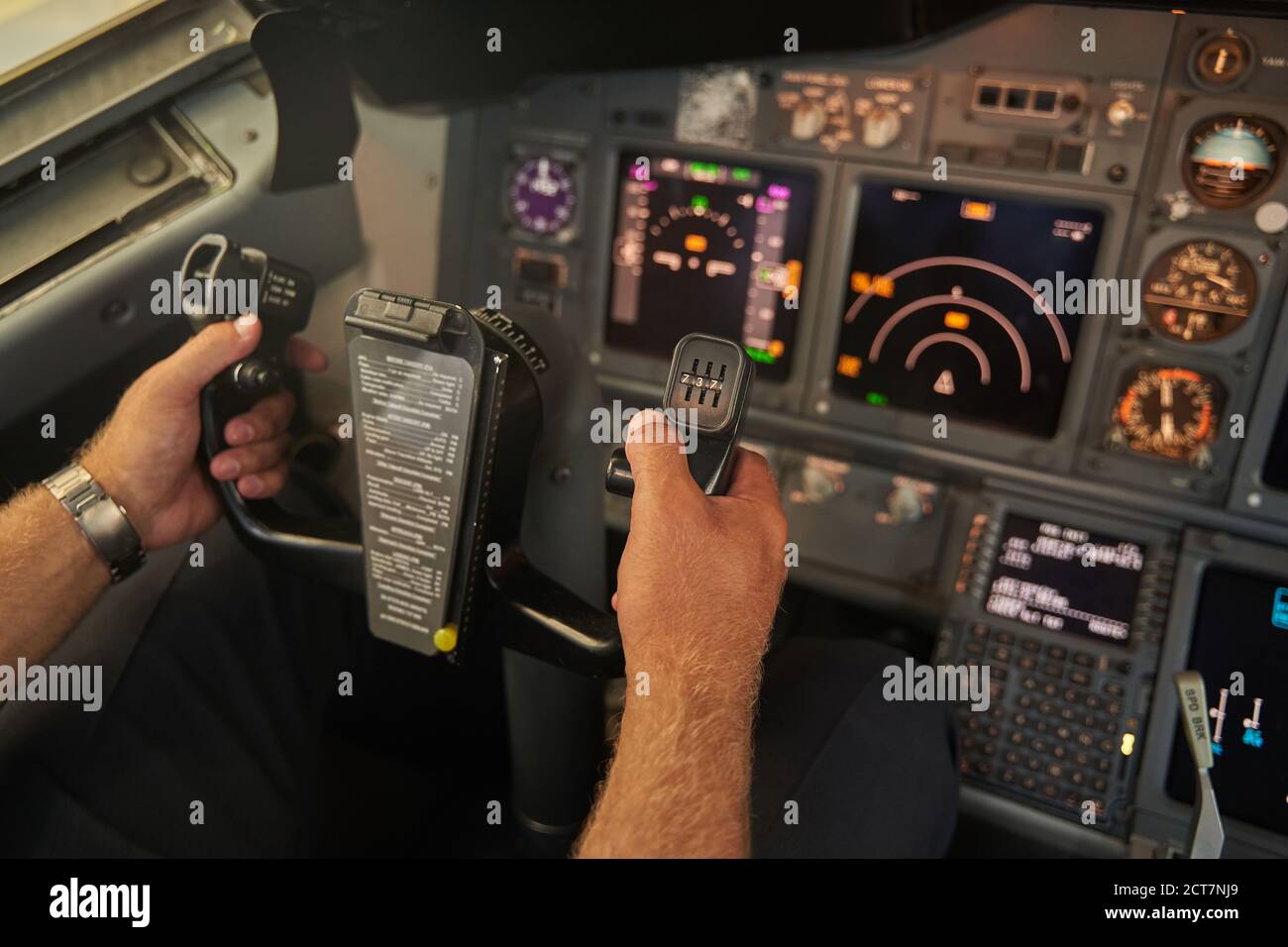 Professional male pilot navigating the passenger aircraft Stock Photo ...