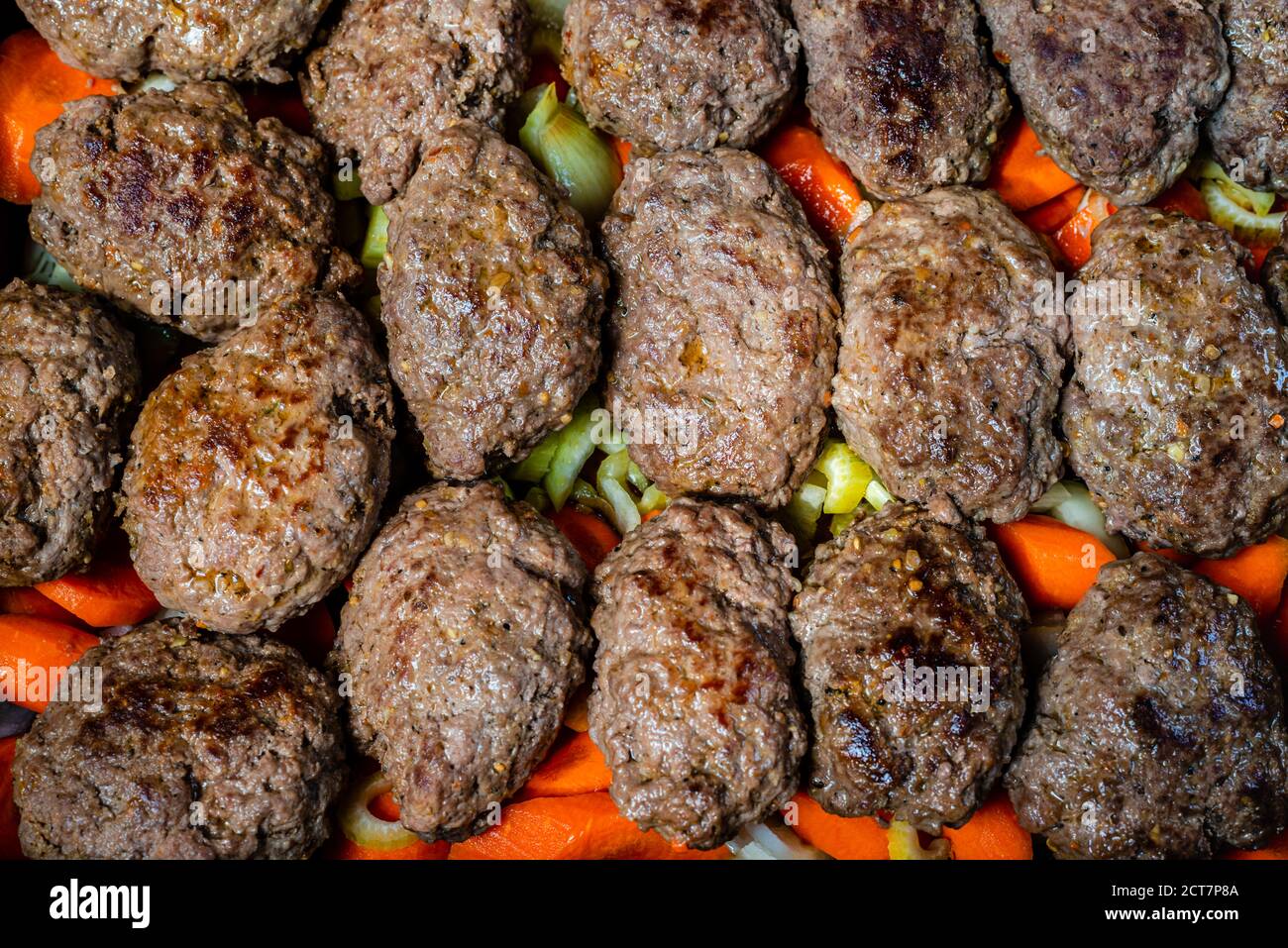 Fried hamburger patties with vegetables prepared for cooking in the ...