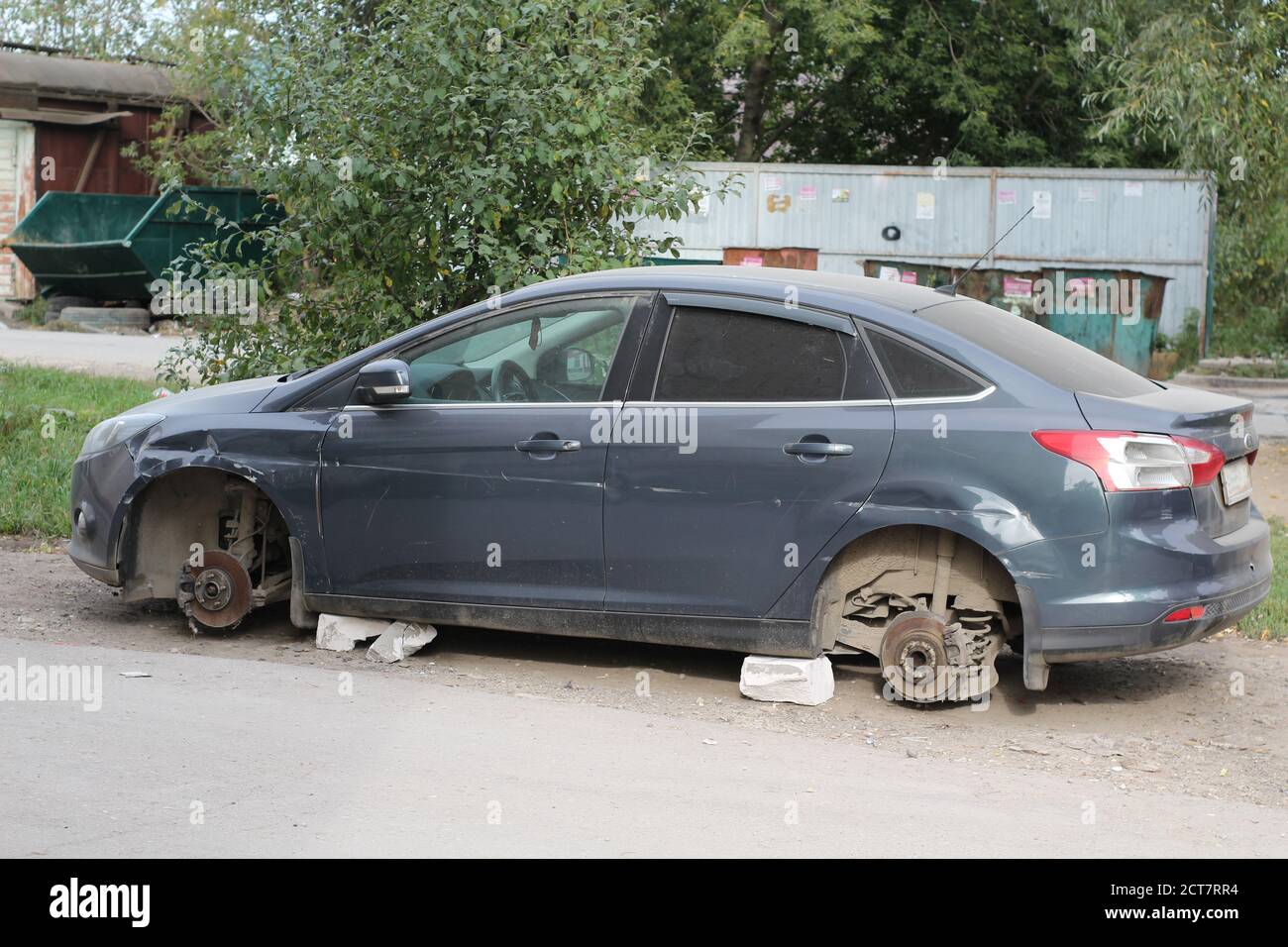 Old rusty broken trash car with a long scratch on the side after crash ...