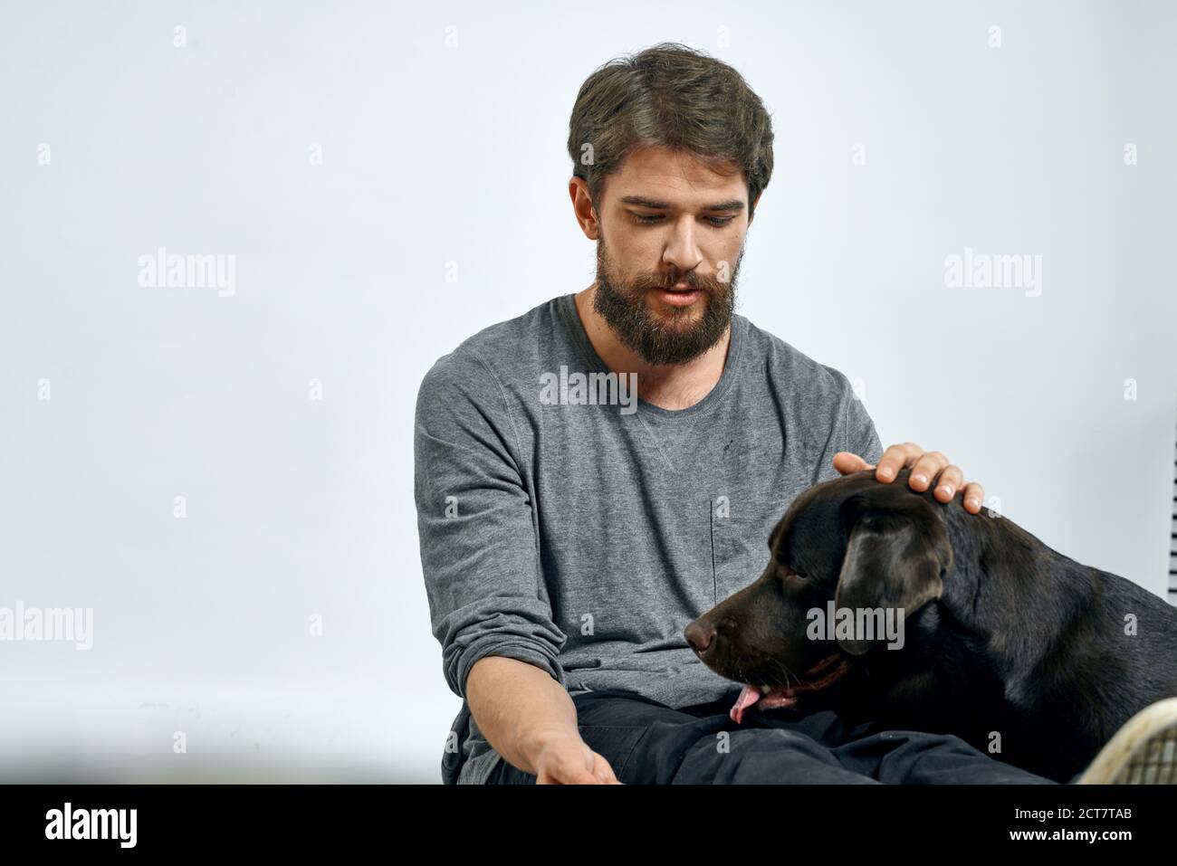 happy owner with pet black dog training model emotions Stock Photo - Alamy