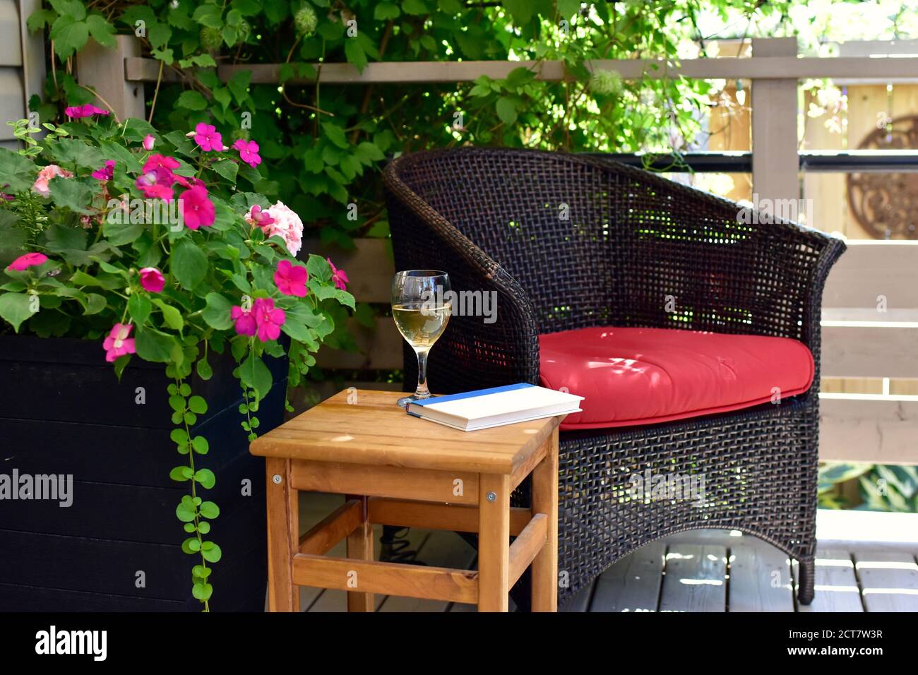 Outdoor secluded patio deck in landscaped backyard garden with cosy ...