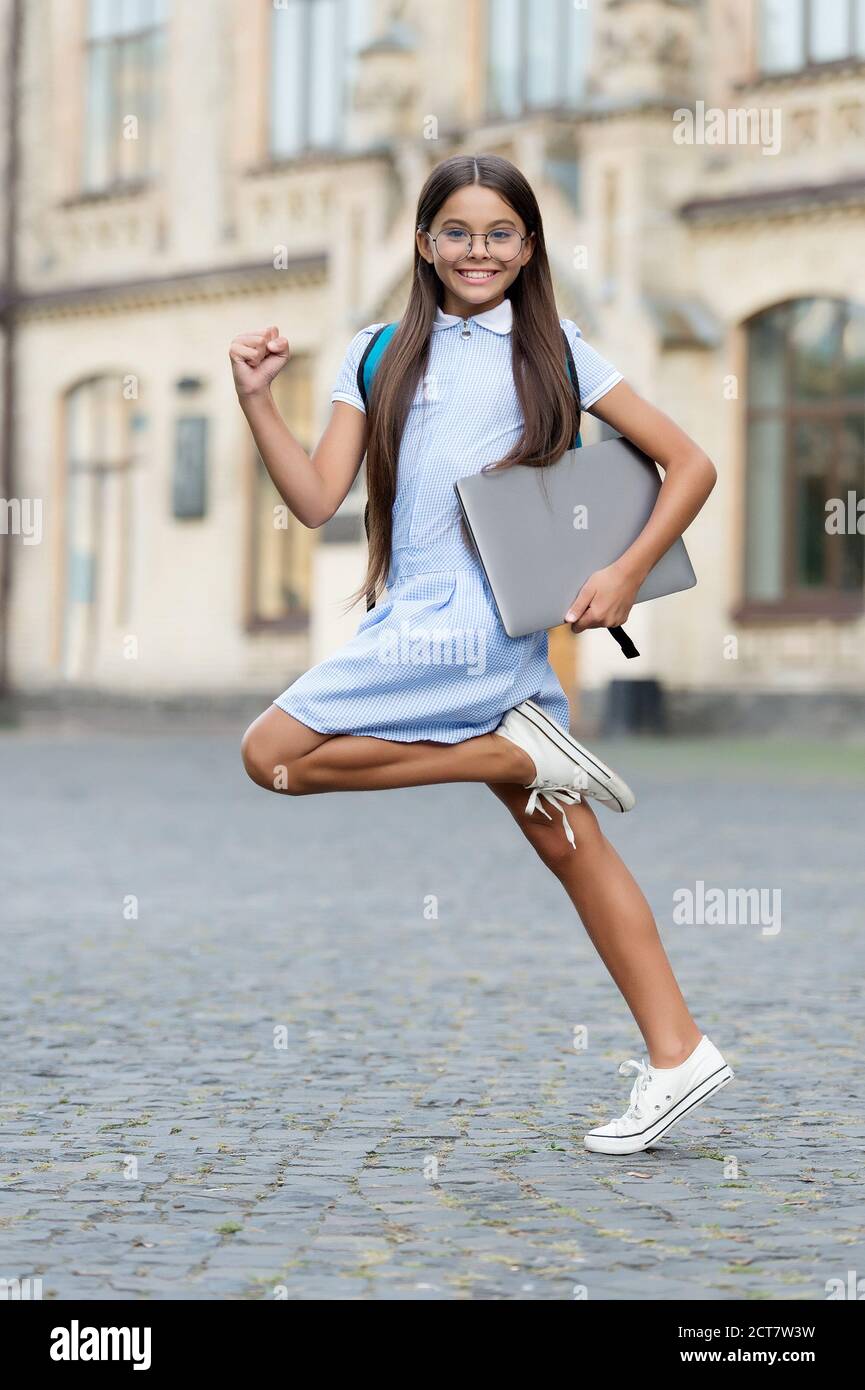 Learning needs change fast. Happy child hurry to school. Little girl ...