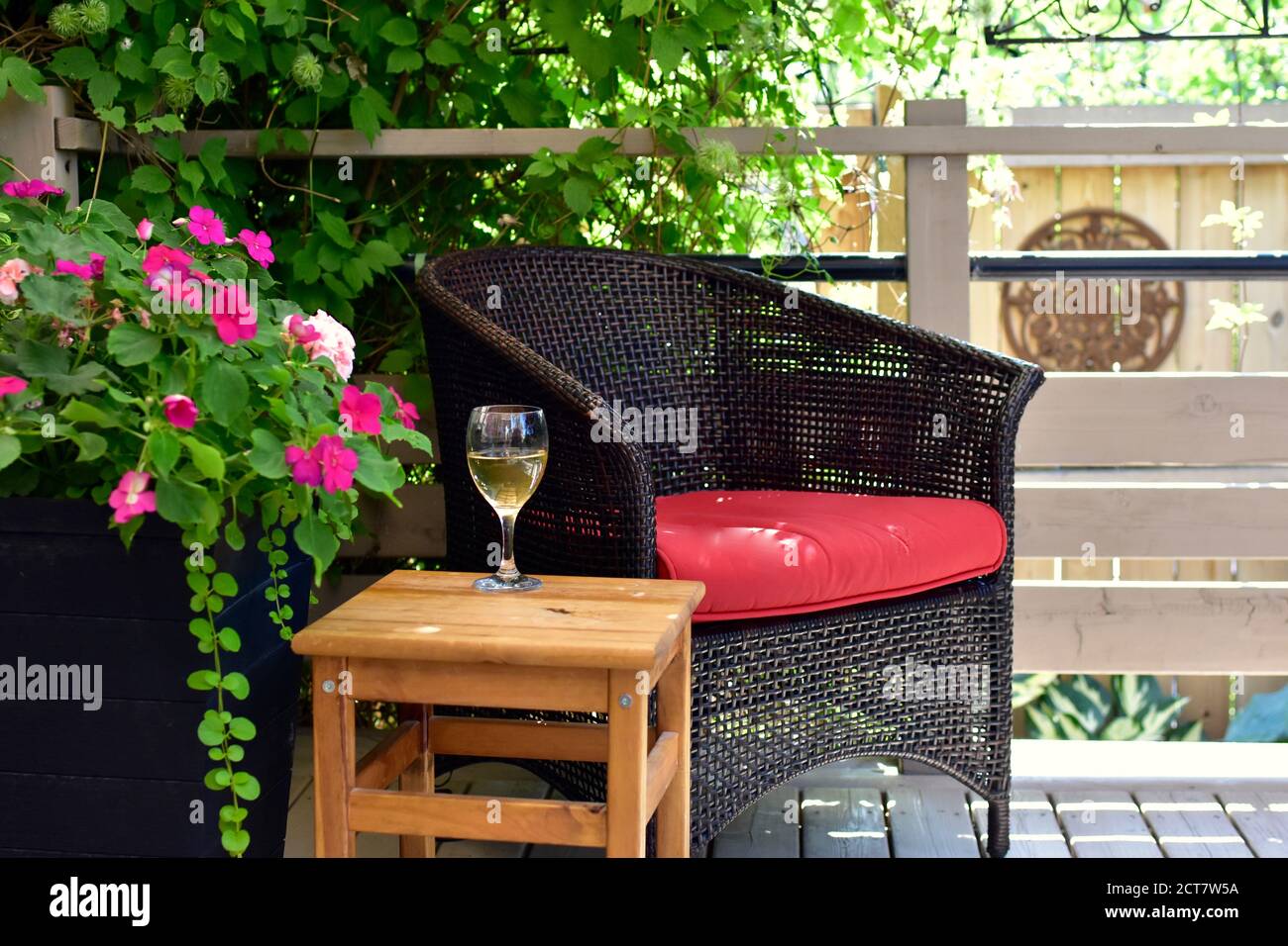 Outdoor secluded patio deck in landscaped backyard garden with cosy ...