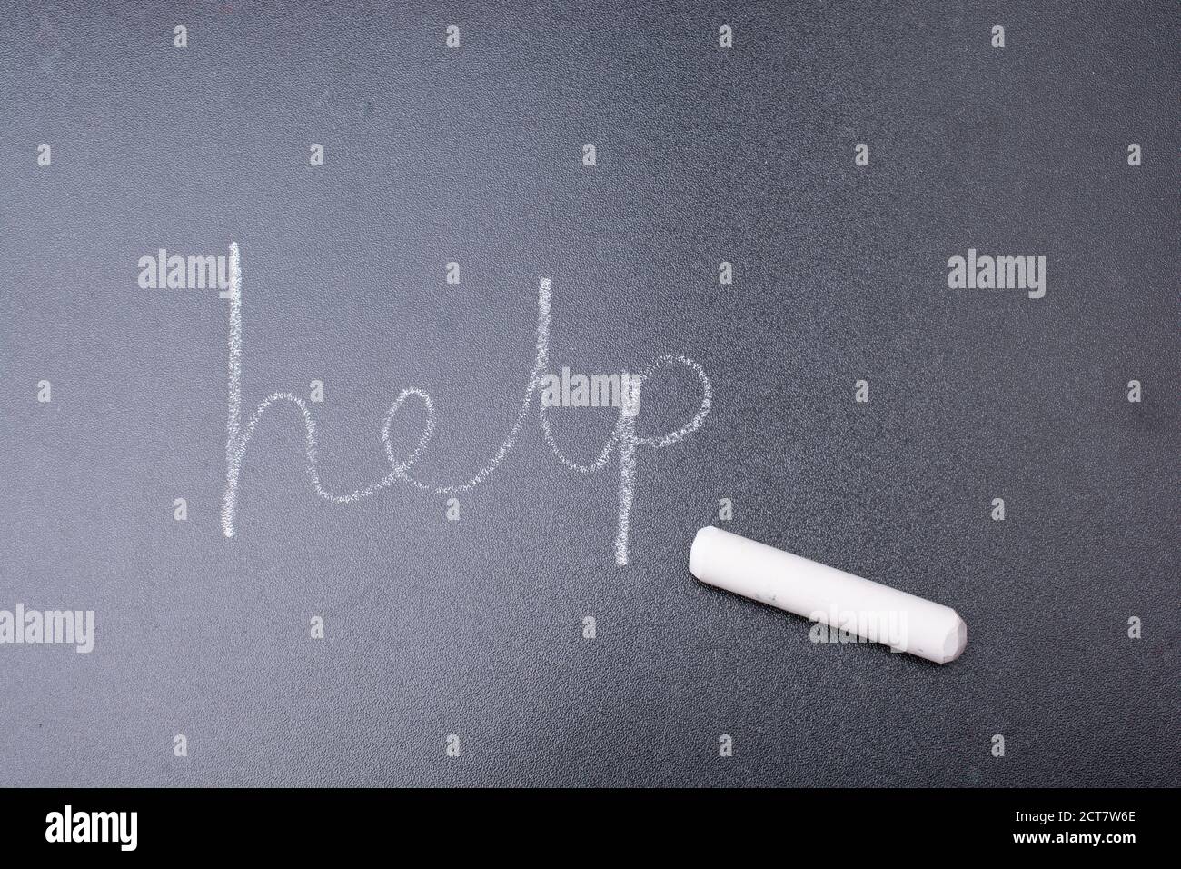 Help word written in chalk on a black chalkboard Stock Photo - Alamy