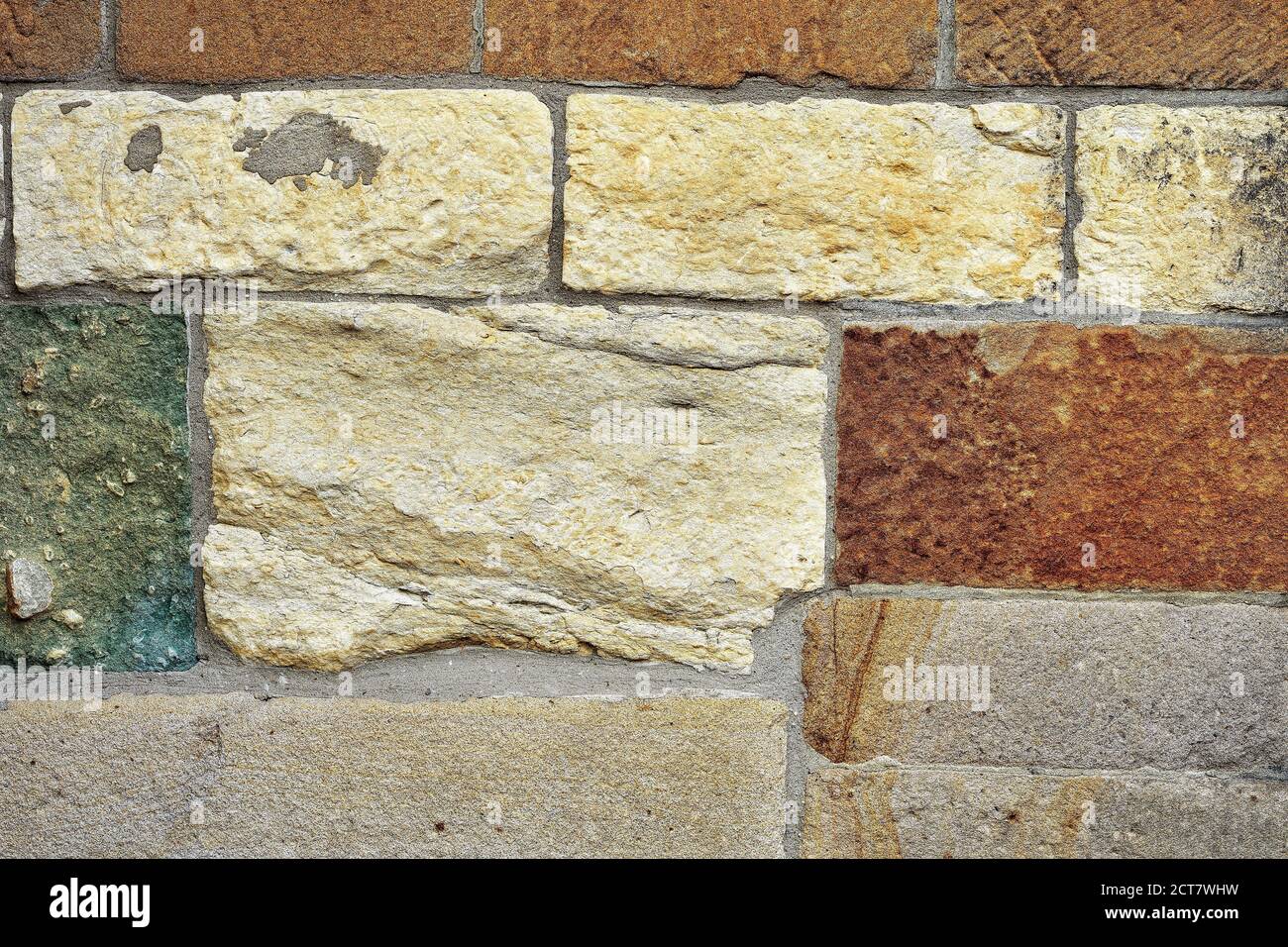 Colorful house wall of sandstone bricks. Natural texture background ...
