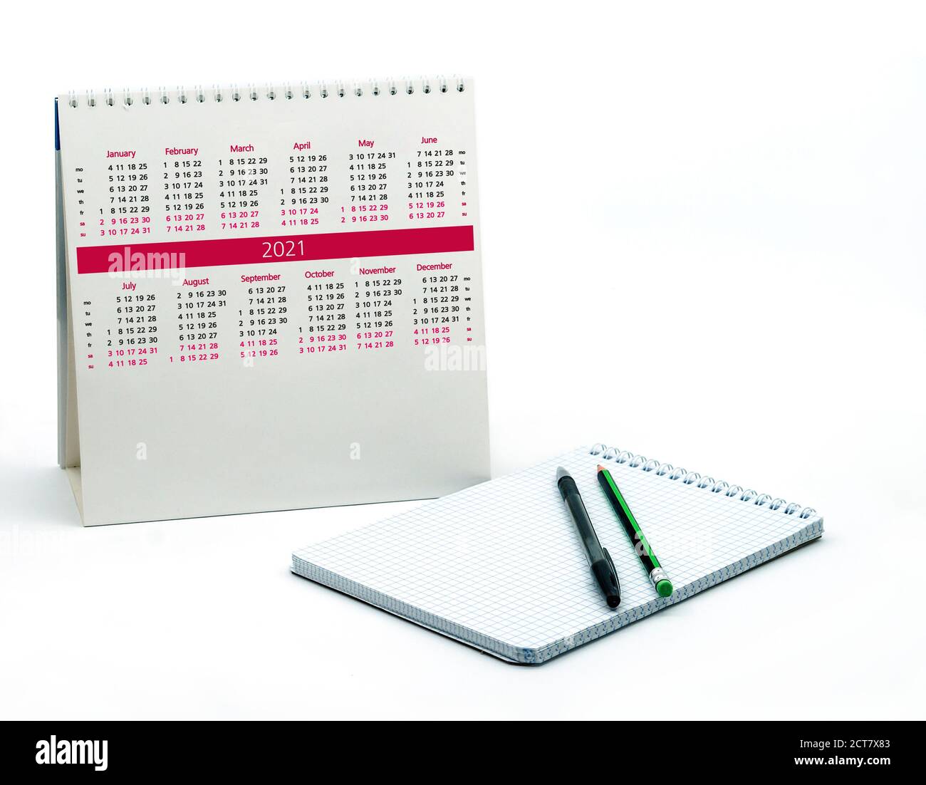 Notepad and calendar 2021, pen and pencil and with a Notepad on a white ...