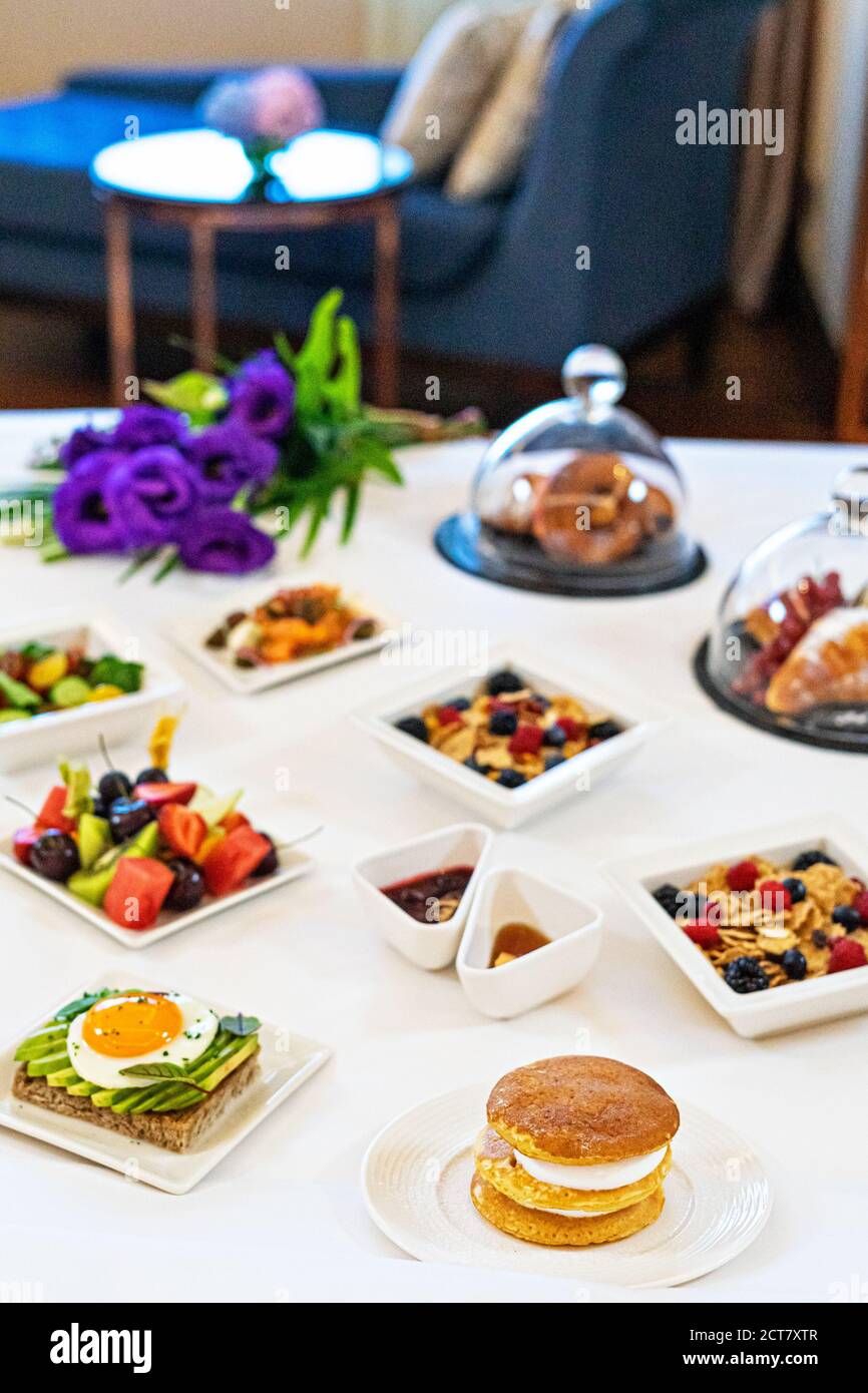 Tray plates with assorted breakfast meal on a bed in a hotel room Stock ...