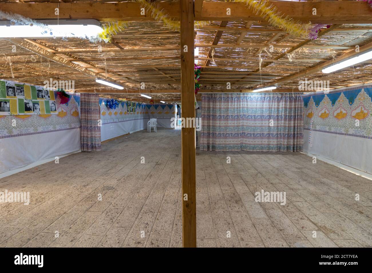 An inside view of an ornate sukkah, a Jewish building for sitting on ...