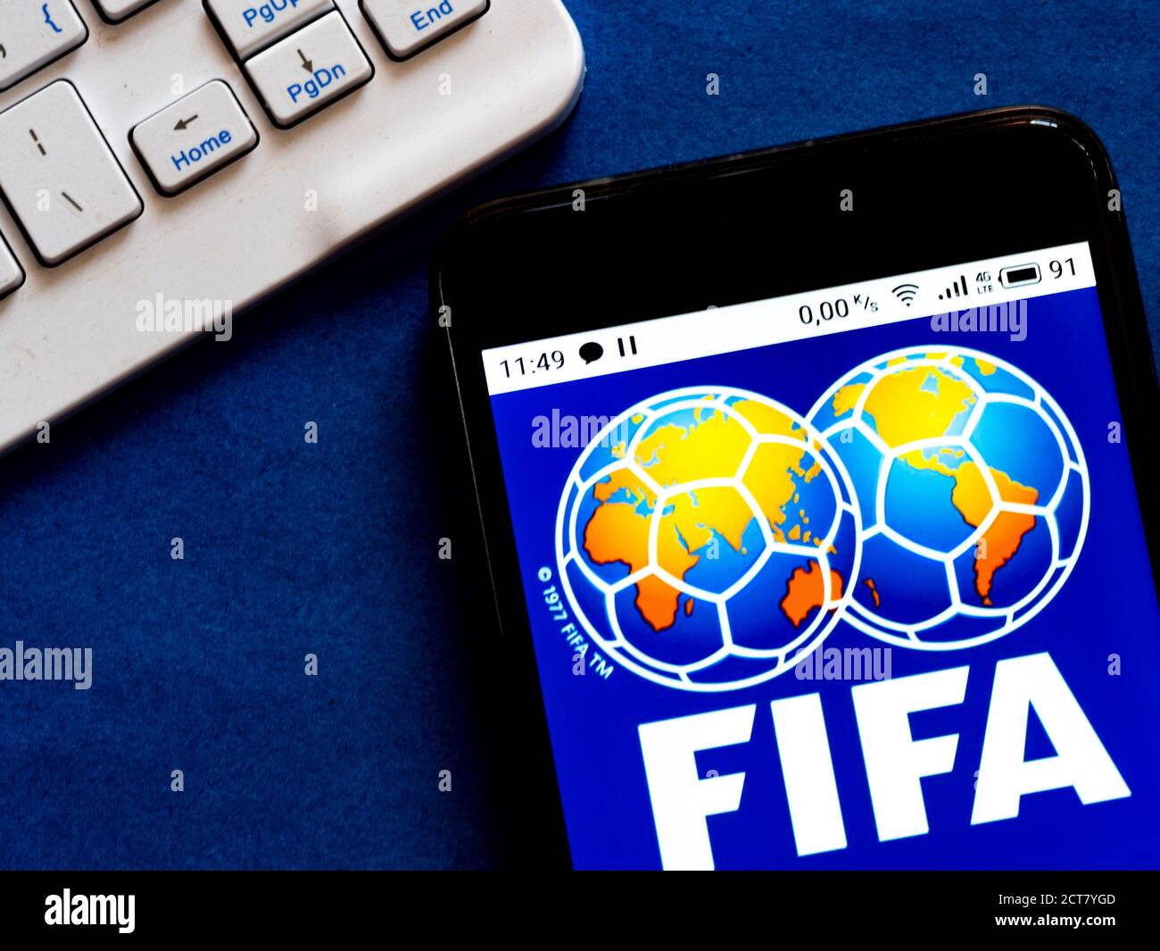 In this photo illustration a FIFA logo seen displayed on a smartphone ...