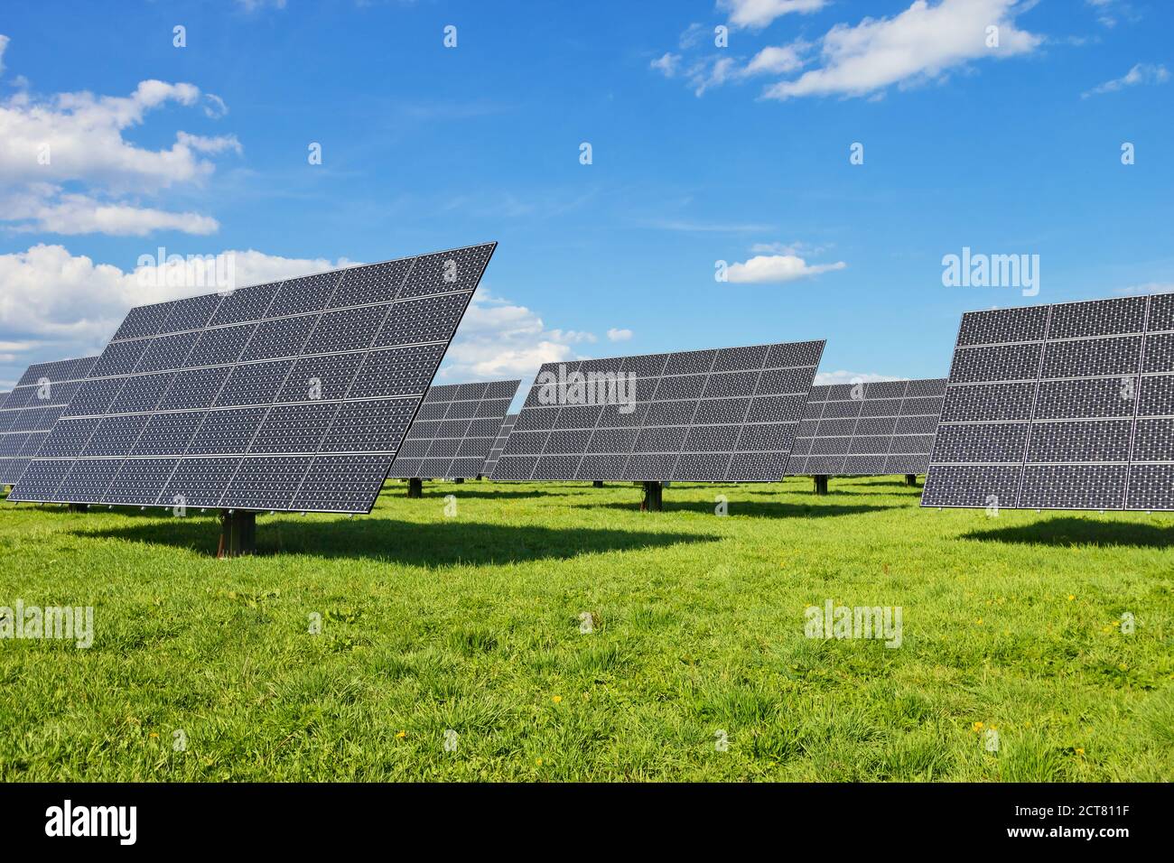 Solar power plant on green meadow Stock Photo - Alamy