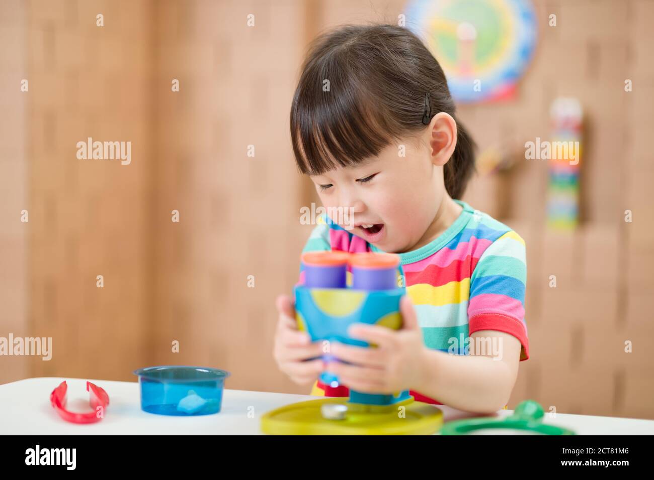 young girl play microscope for homeschooling Stock Photo - Alamy
