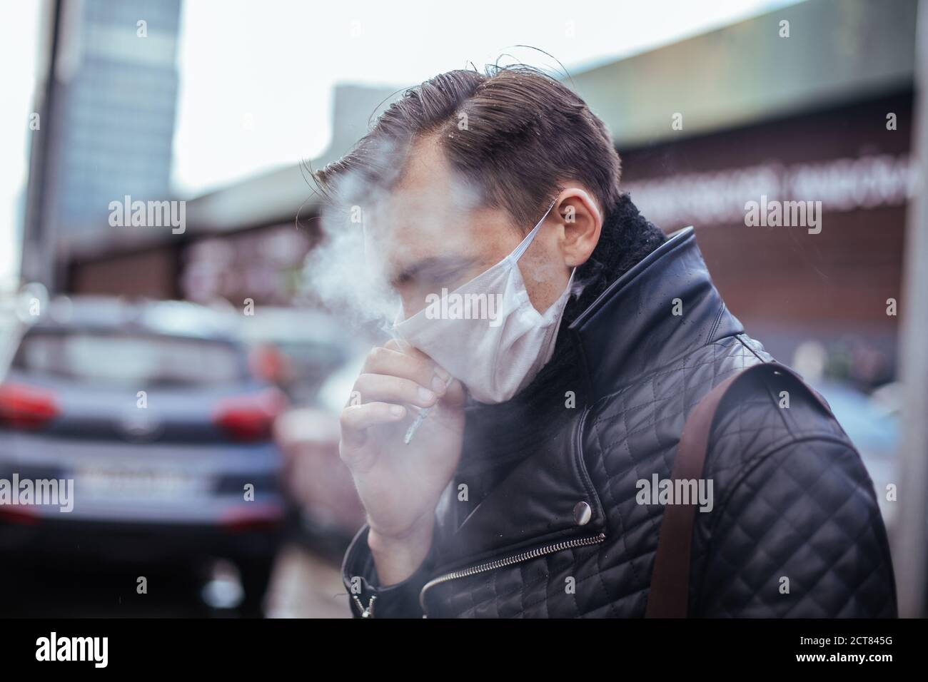 close up. casual man Smoking standing on the street Stock Photo - Alamy