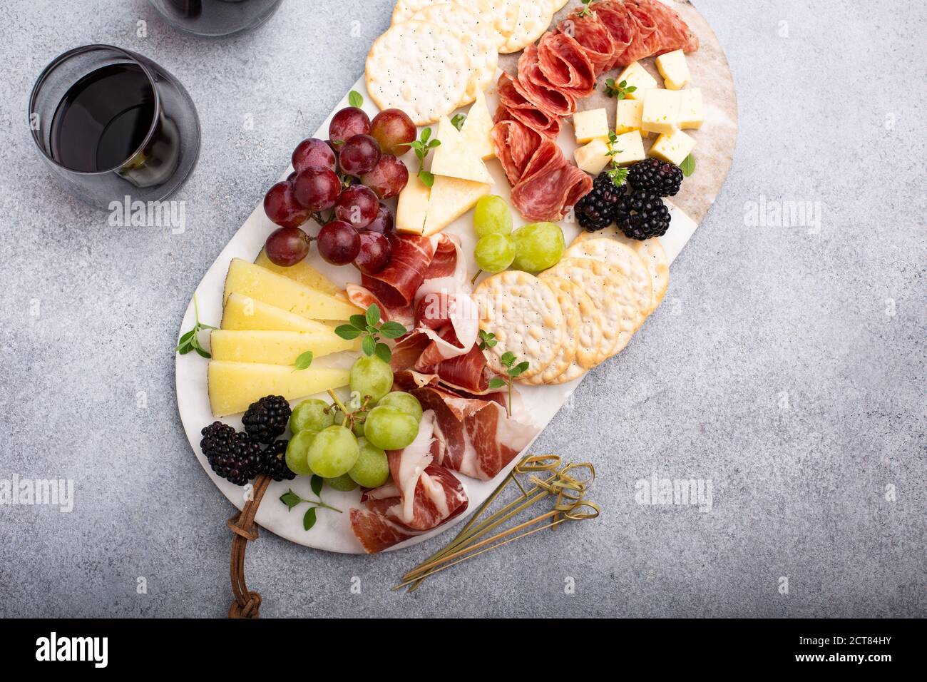 Cheese or snack board with meat and fruit Stock Photo - Alamy