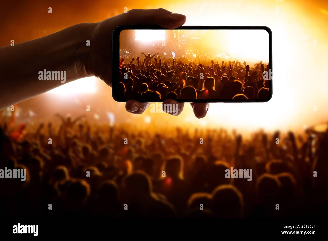 Using technology at the event. Mobile phone in hand Stock Photo - Alamy