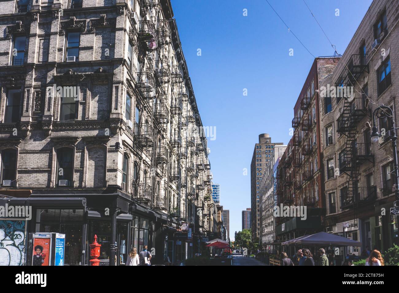 Lower East side block with apartment buildings and outdoor seating ...