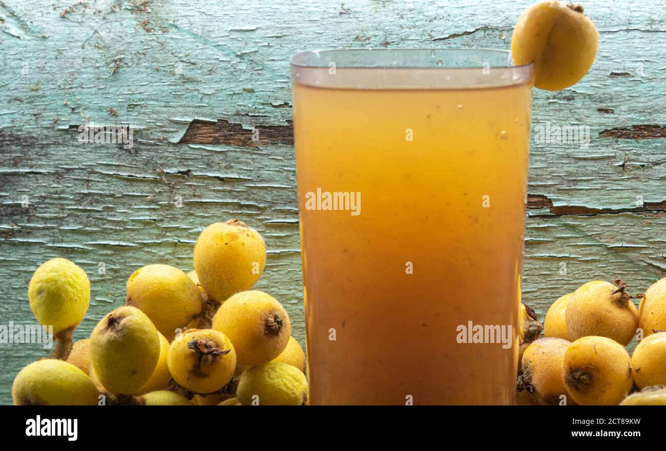 Yellow loquat juice. Refreshing drink and detox. Natural food. Exotic ...
