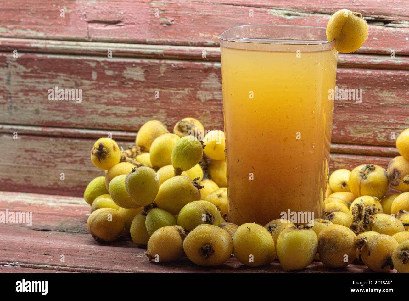 Yellow loquat juice. Refreshing drink and detox. Natural food. Exotic ...