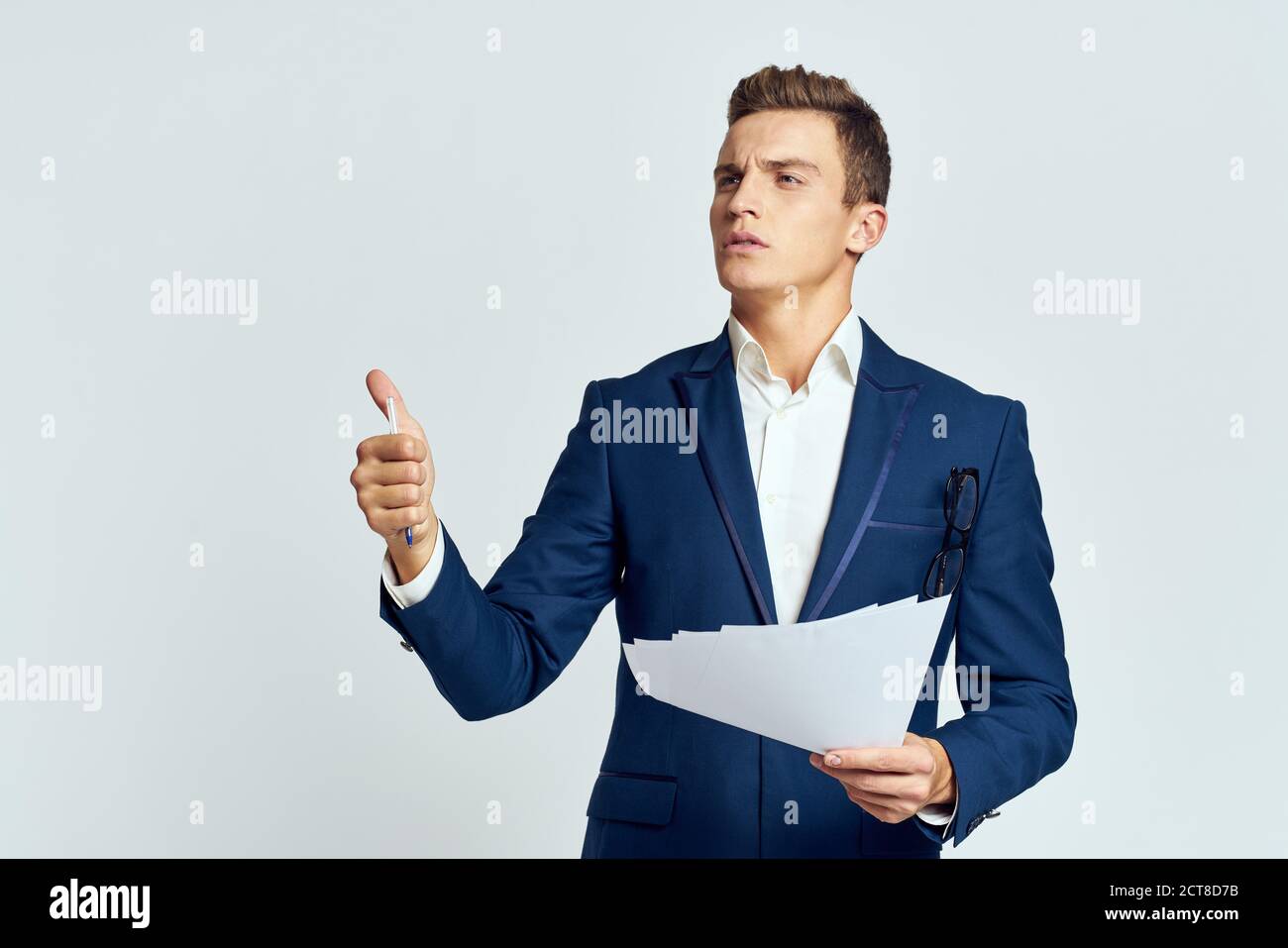 A business man in a suit holds a paper in the hand of an official ...
