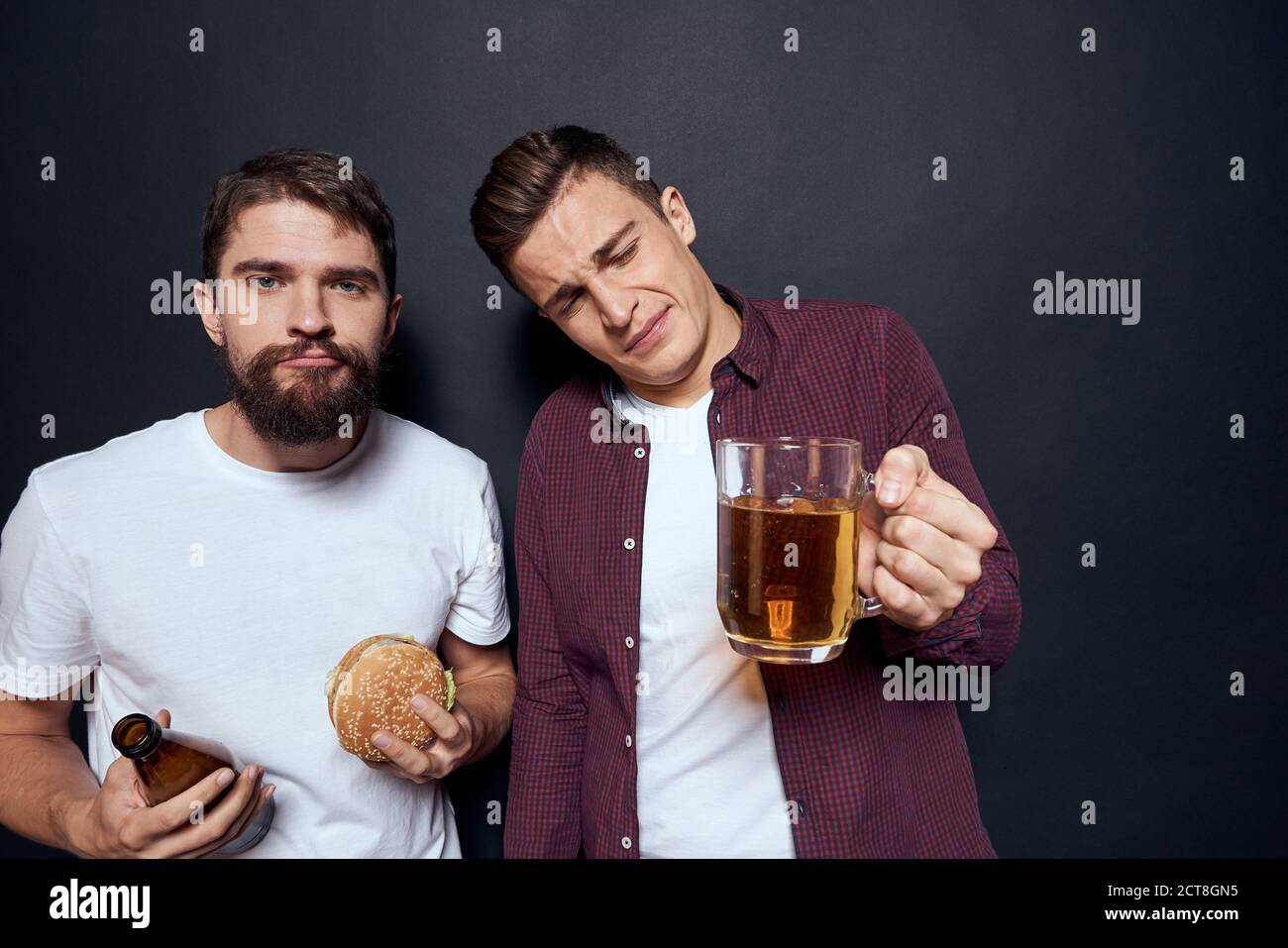 Two drunk friends drinking beer rest fun dark background Stock Photo ...