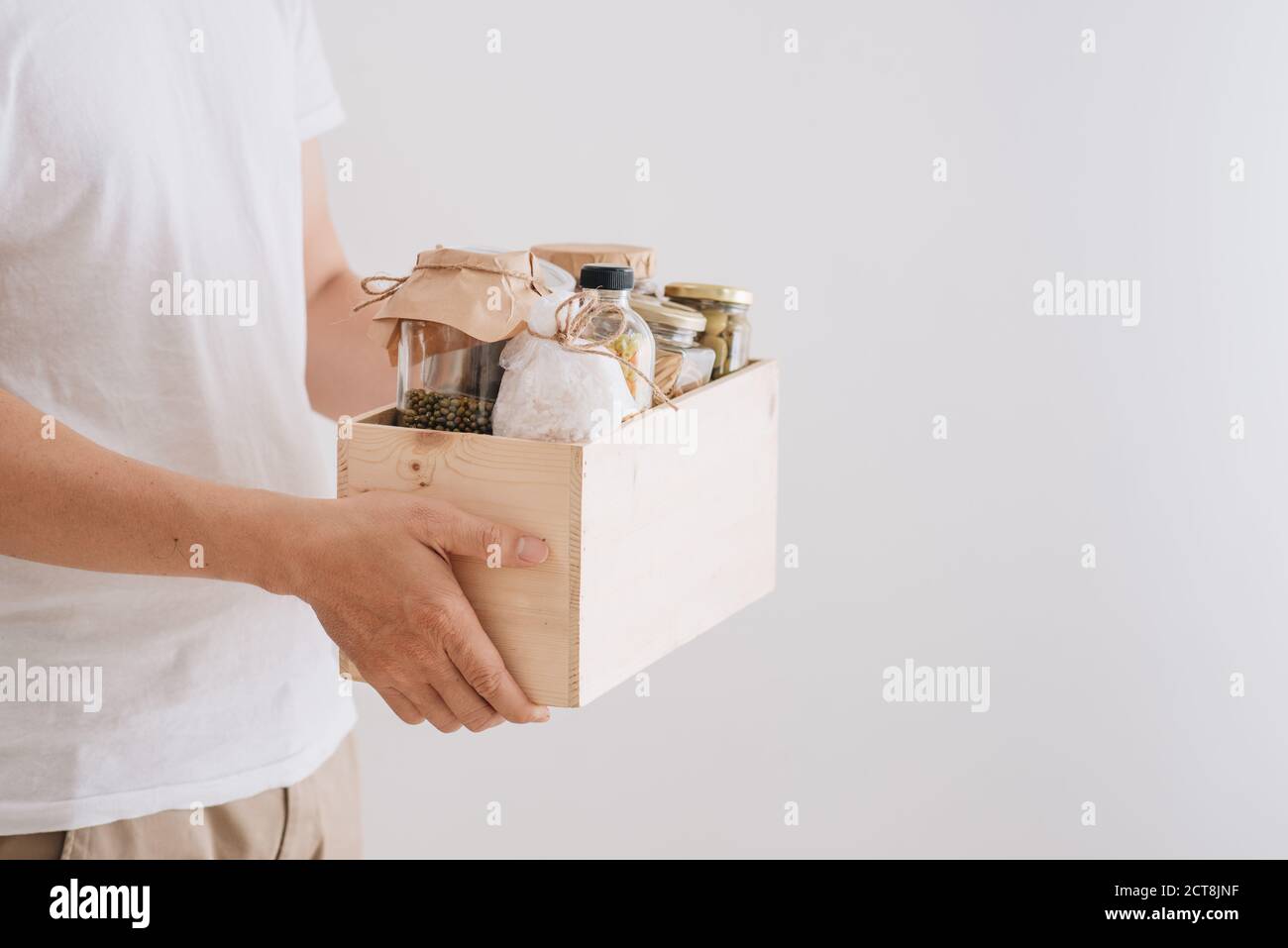 Volunteer with box of food for poor. Donation concept Stock Photo - Alamy