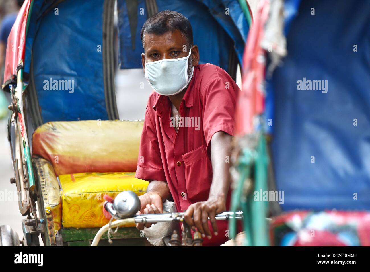 Beijing, China. 22nd Sep, 2020. A rickshaw puller wearing a face mask ...