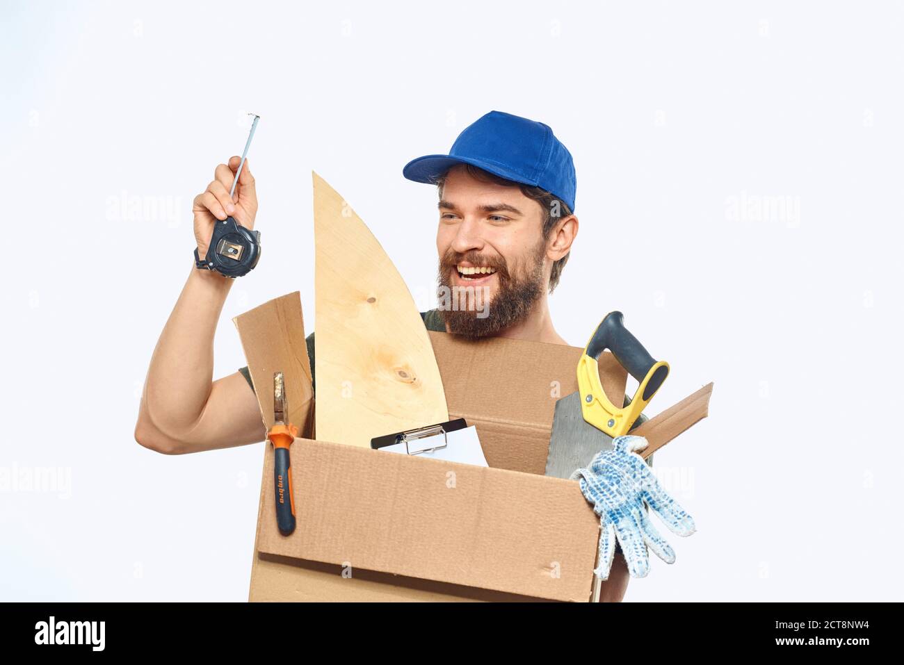 Worker man in uniform with a box in his hands tools delivery service ...