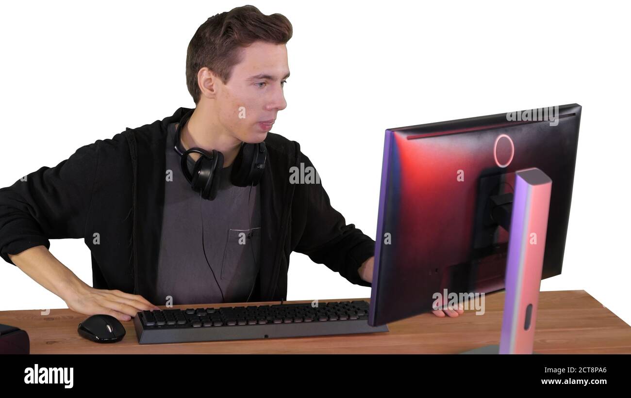Nervous man watching video games on a PC computer on white backg Stock ...