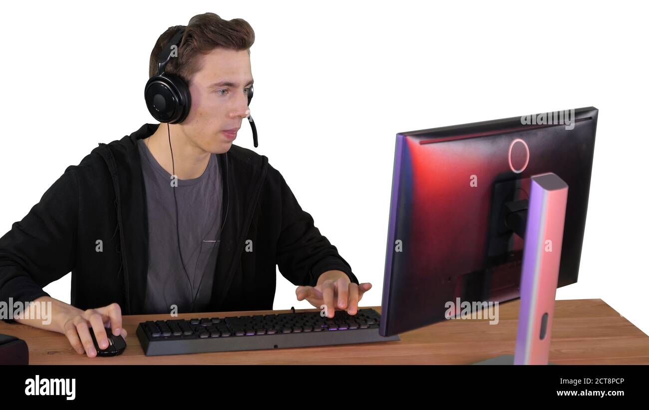 Gamer guy in headphones playing video games on computer and winn Stock ...