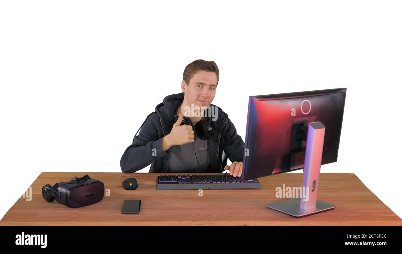 Young gamer shows a thumbs up and looks into the camera on white Stock ...